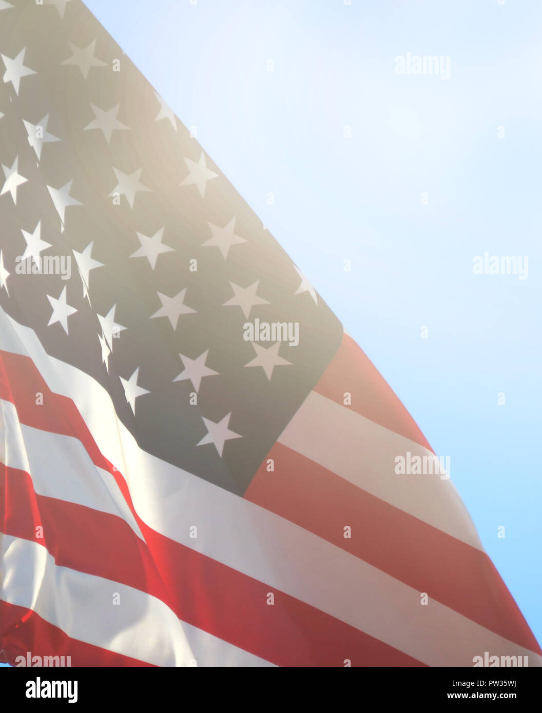 flag of America against the blue sky with sun rays Stock Photo - Alamy