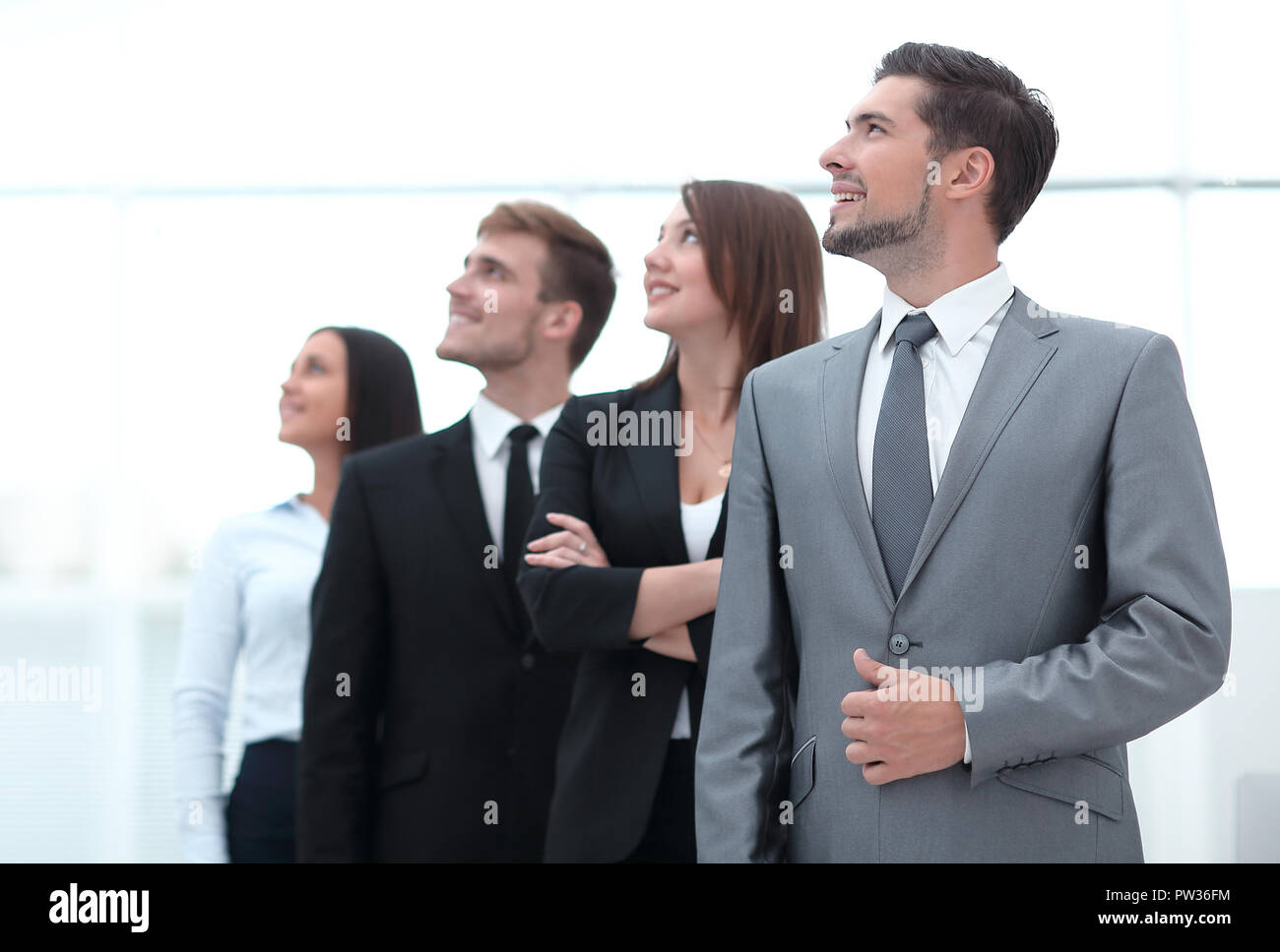 business team standing one behind the other and looking forward Stock ...