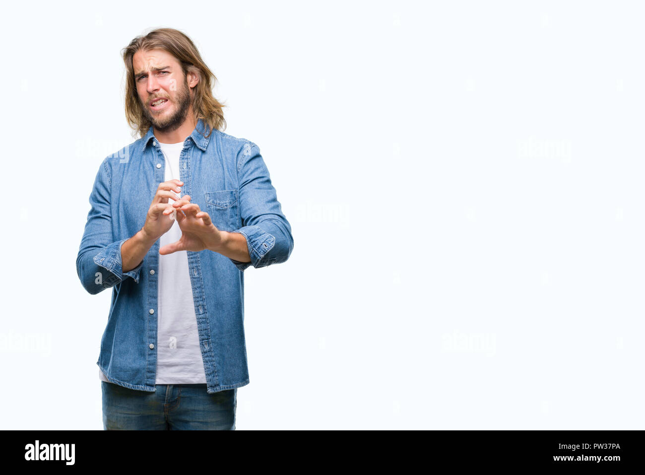 Young handsome man with long hair over isolated background disgusted ...