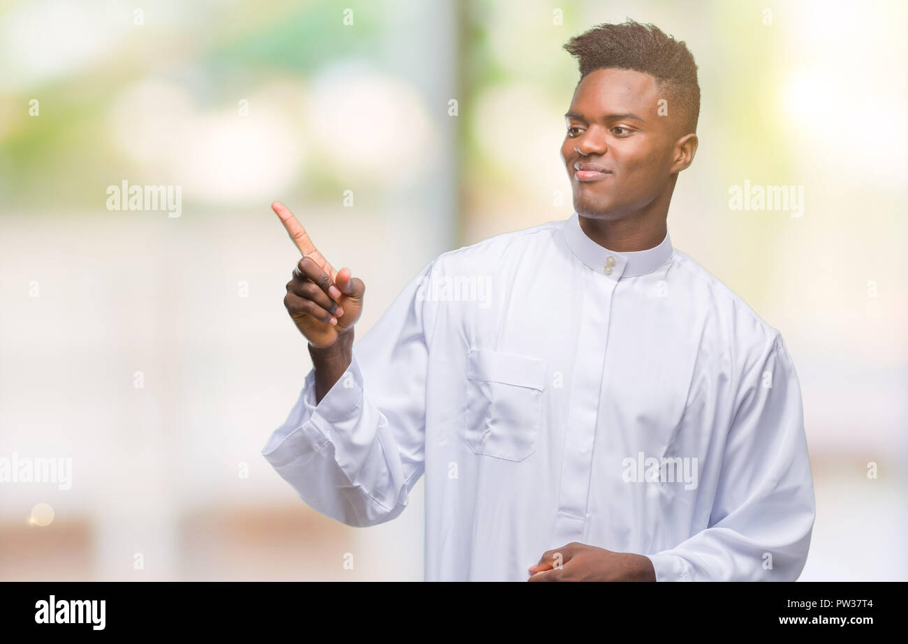 Young arabic african man wearing traditional djellaba over isolated ...