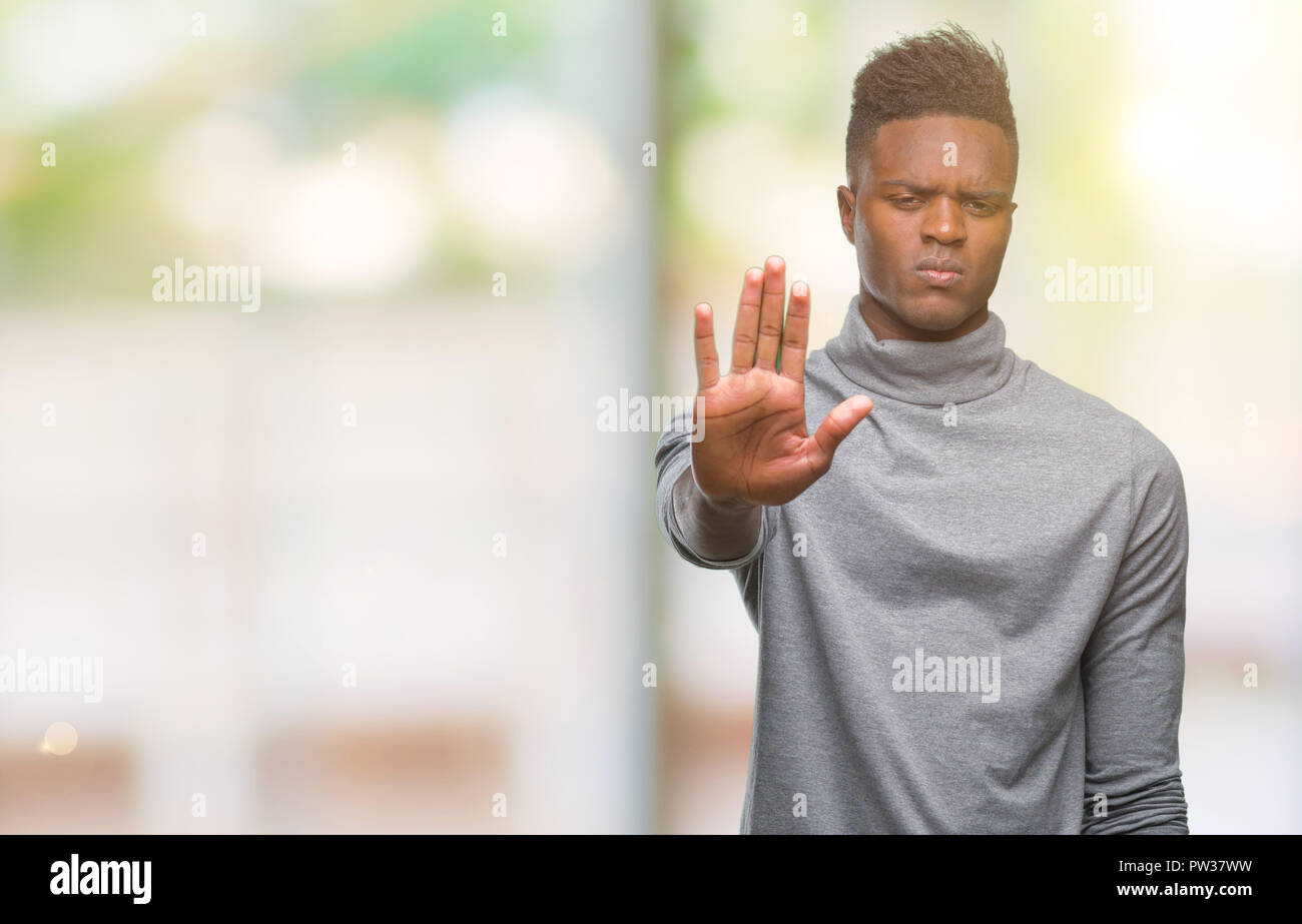 Young african american man over isolated background doing stop sing ...