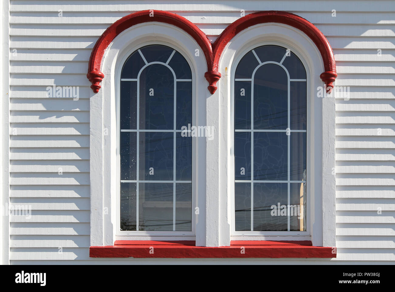 double arched Windows trimmed in red on historic wooden church Stock ...