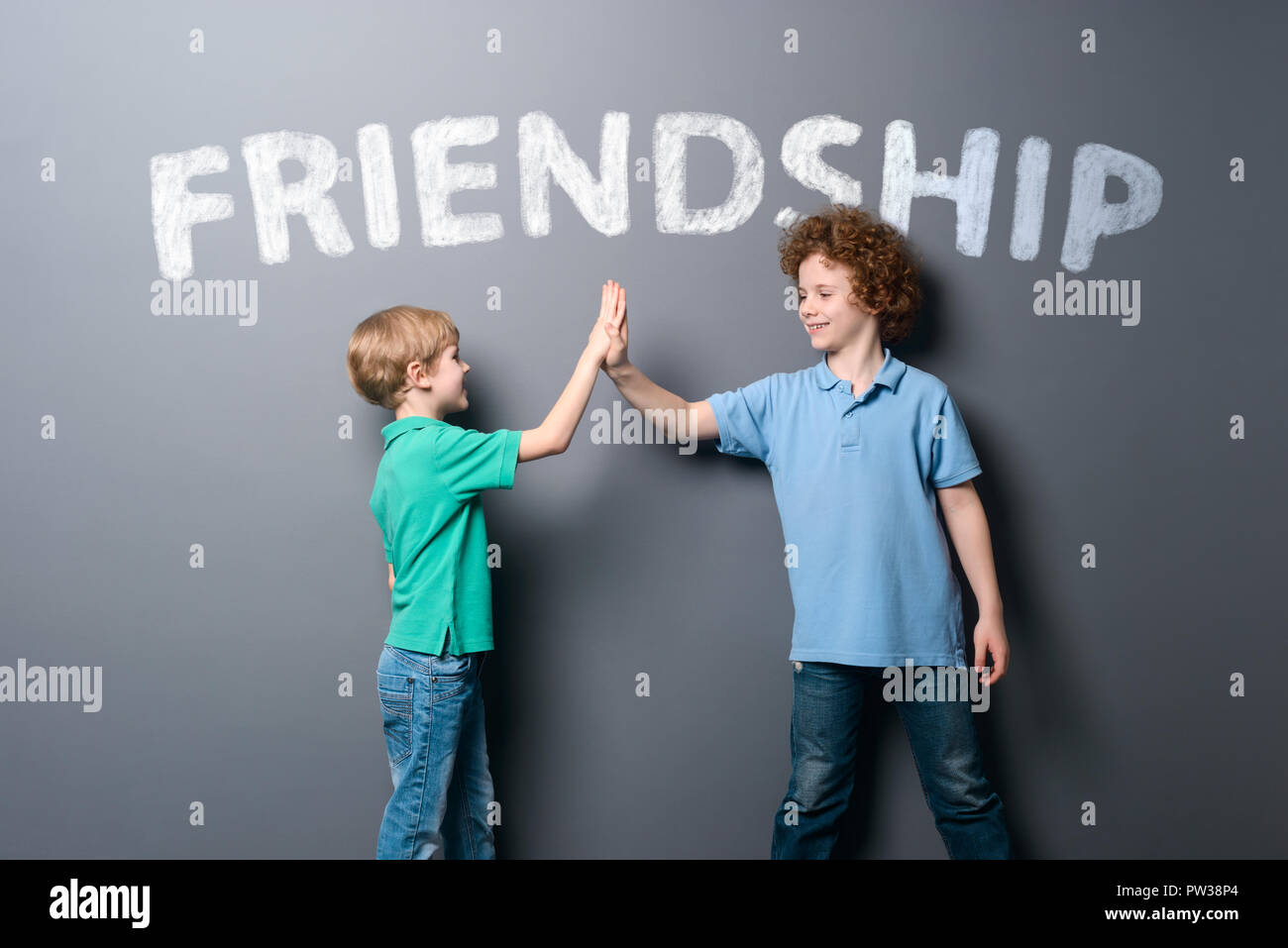 Friends giving a high five Stock Photo - Alamy