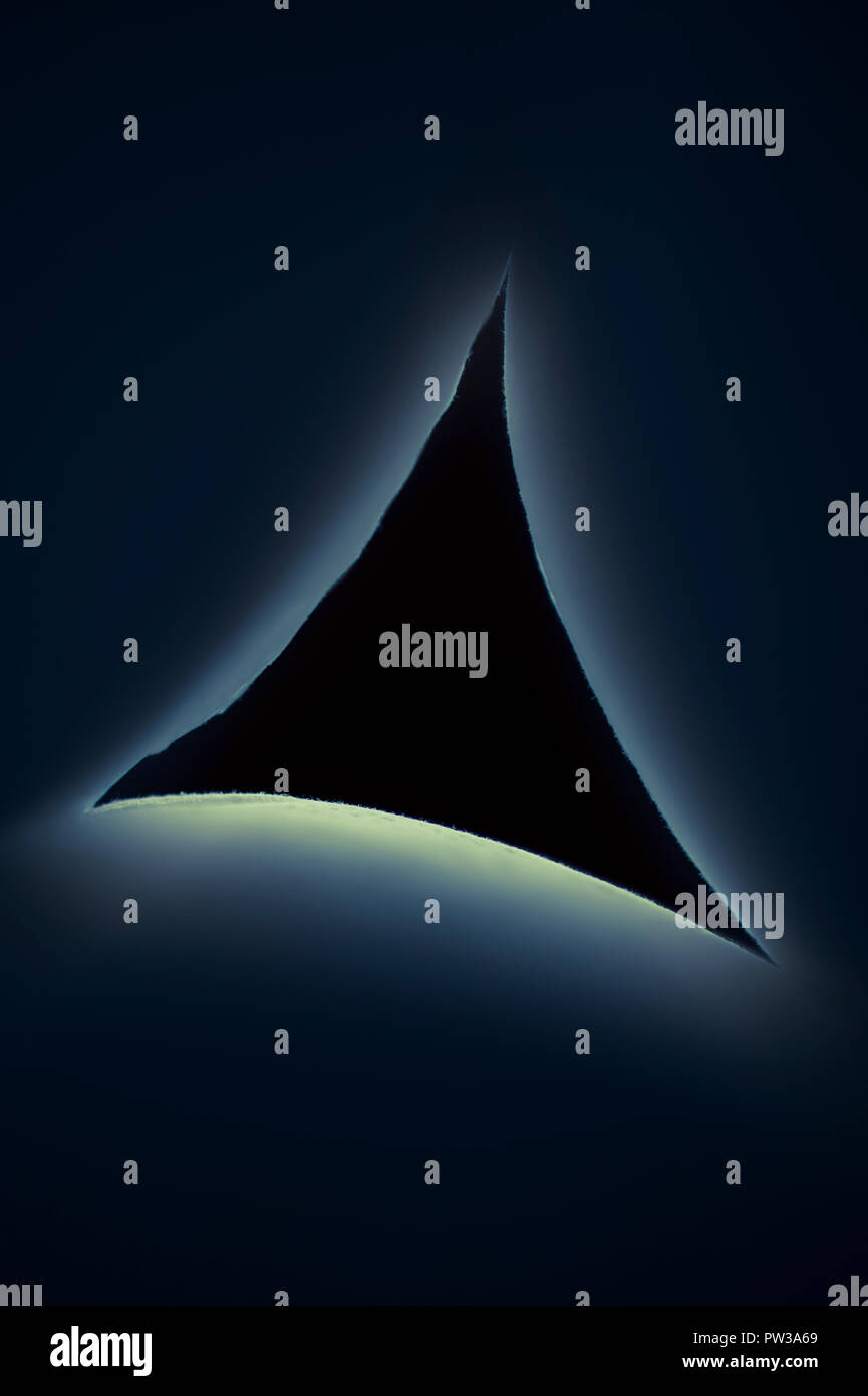 Toilet paper stacked with heavy contrast creating abstract patterns ...