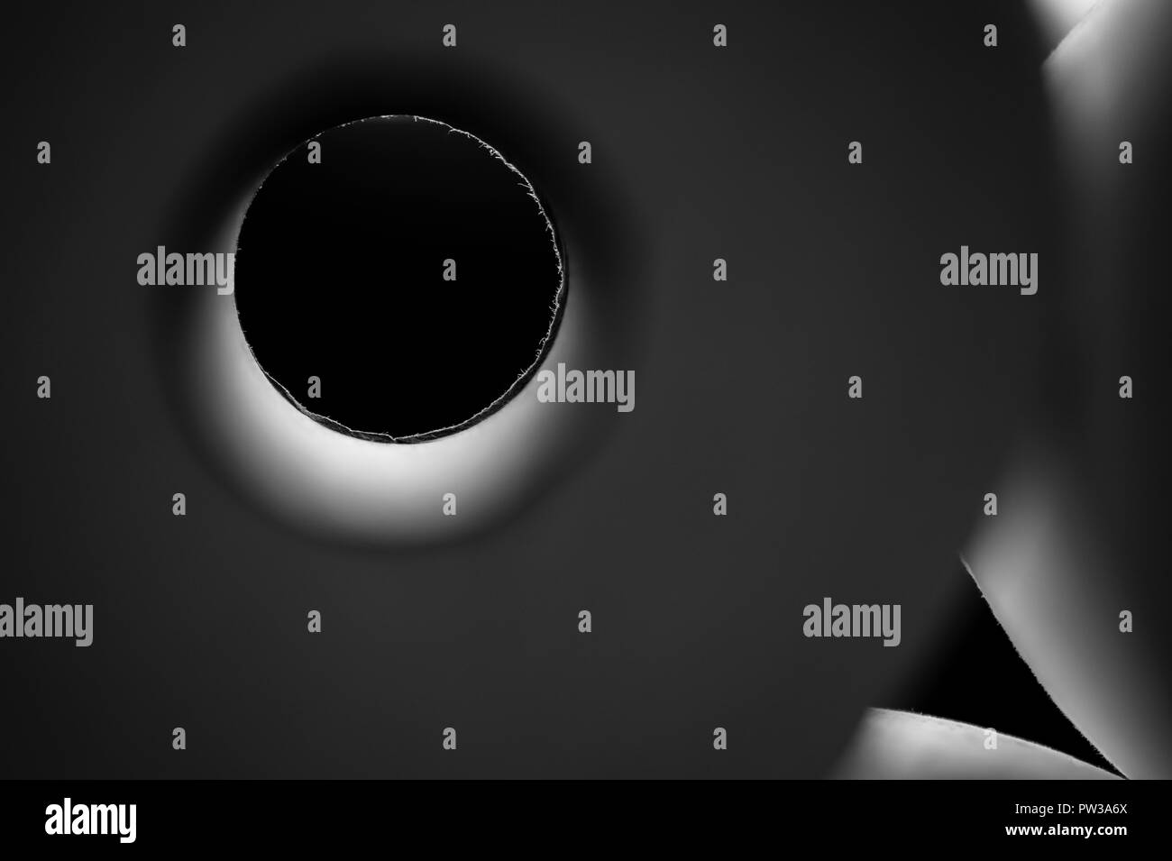 Toilet paper stacked with heavy contrast creating abstract patterns ...