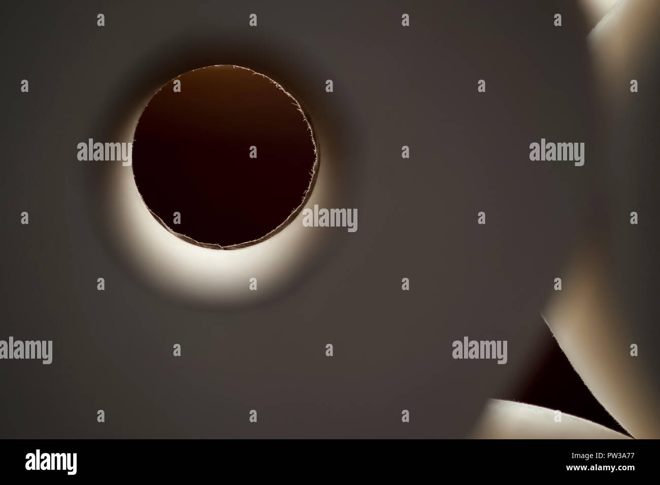 Toilet paper stacked with heavy contrast creating abstract patterns ...