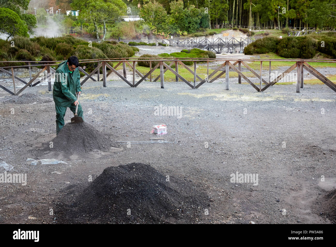 A man digging a hole in Fumarolas da Lagoa das Furnas for Cozido das ...