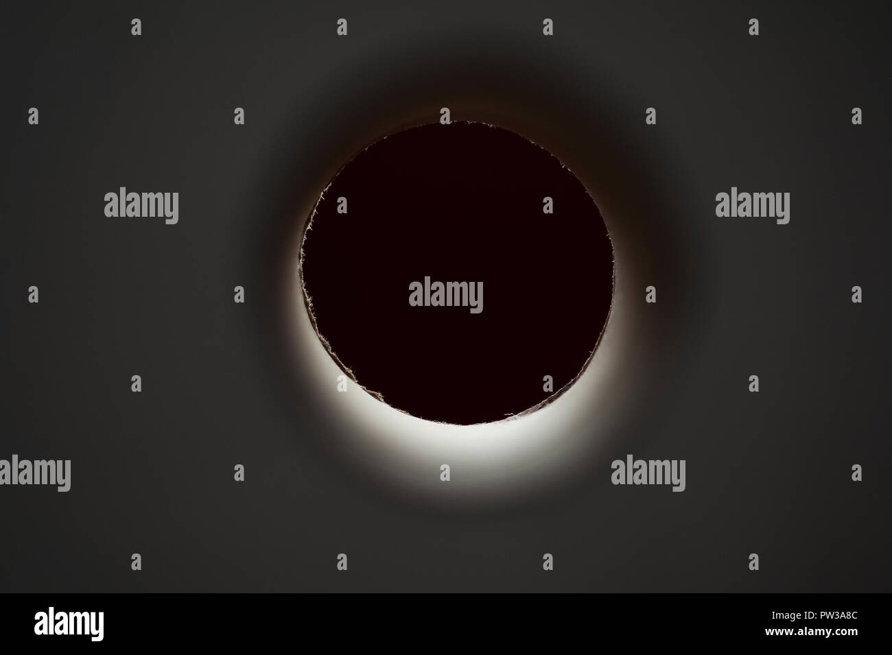 Toilet paper stacked with heavy contrast creating abstract patterns ...