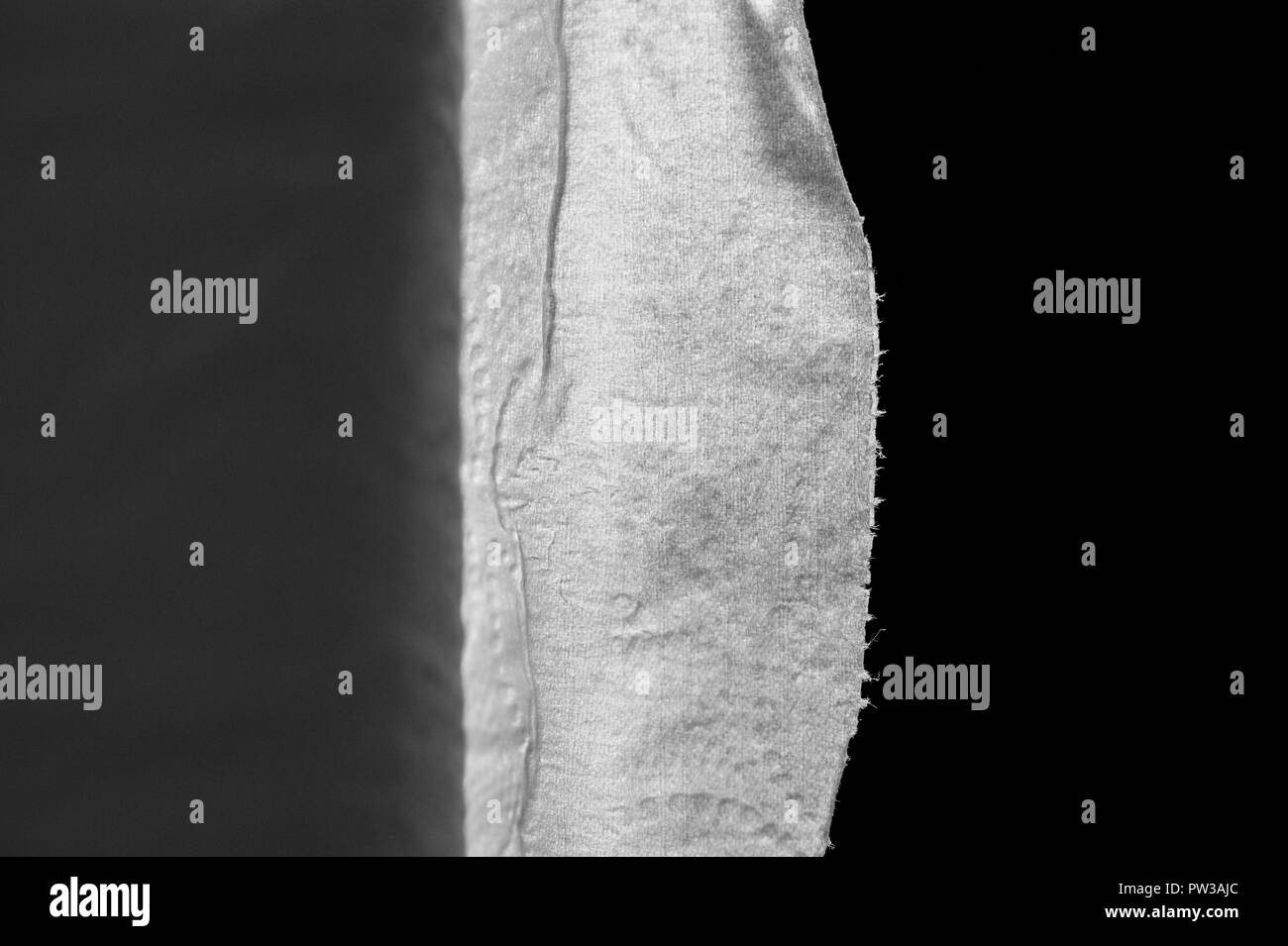 Toilet paper with heavy contrast creating abstract patterns in black ...