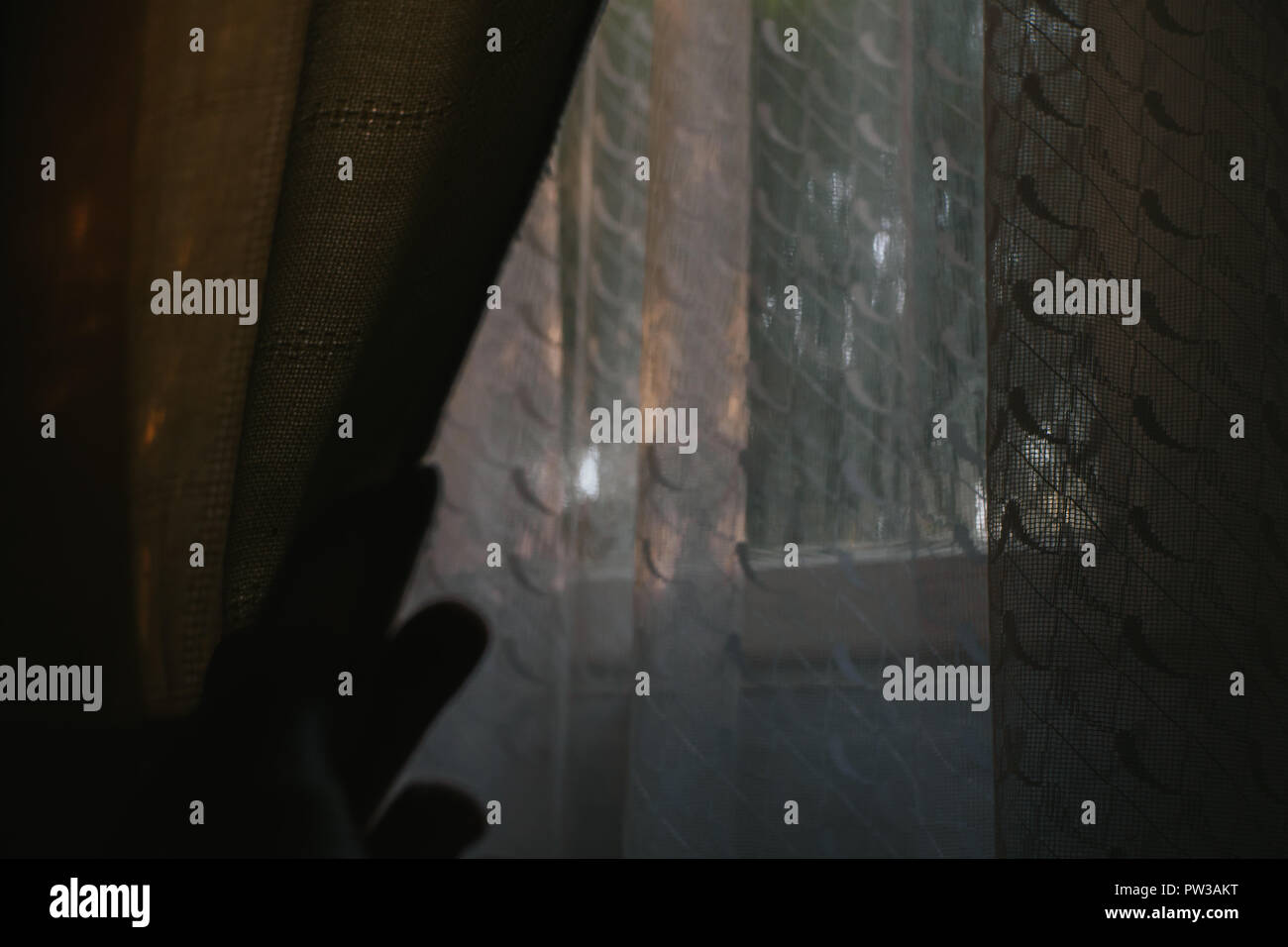 human hand sliding a curtain to the side Stock Photo - Alamy