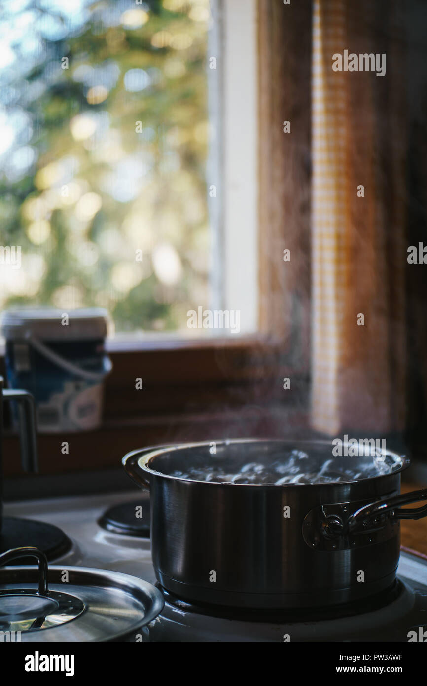 photo of pot filled with potatoes and boiling water on a stove Stock ...