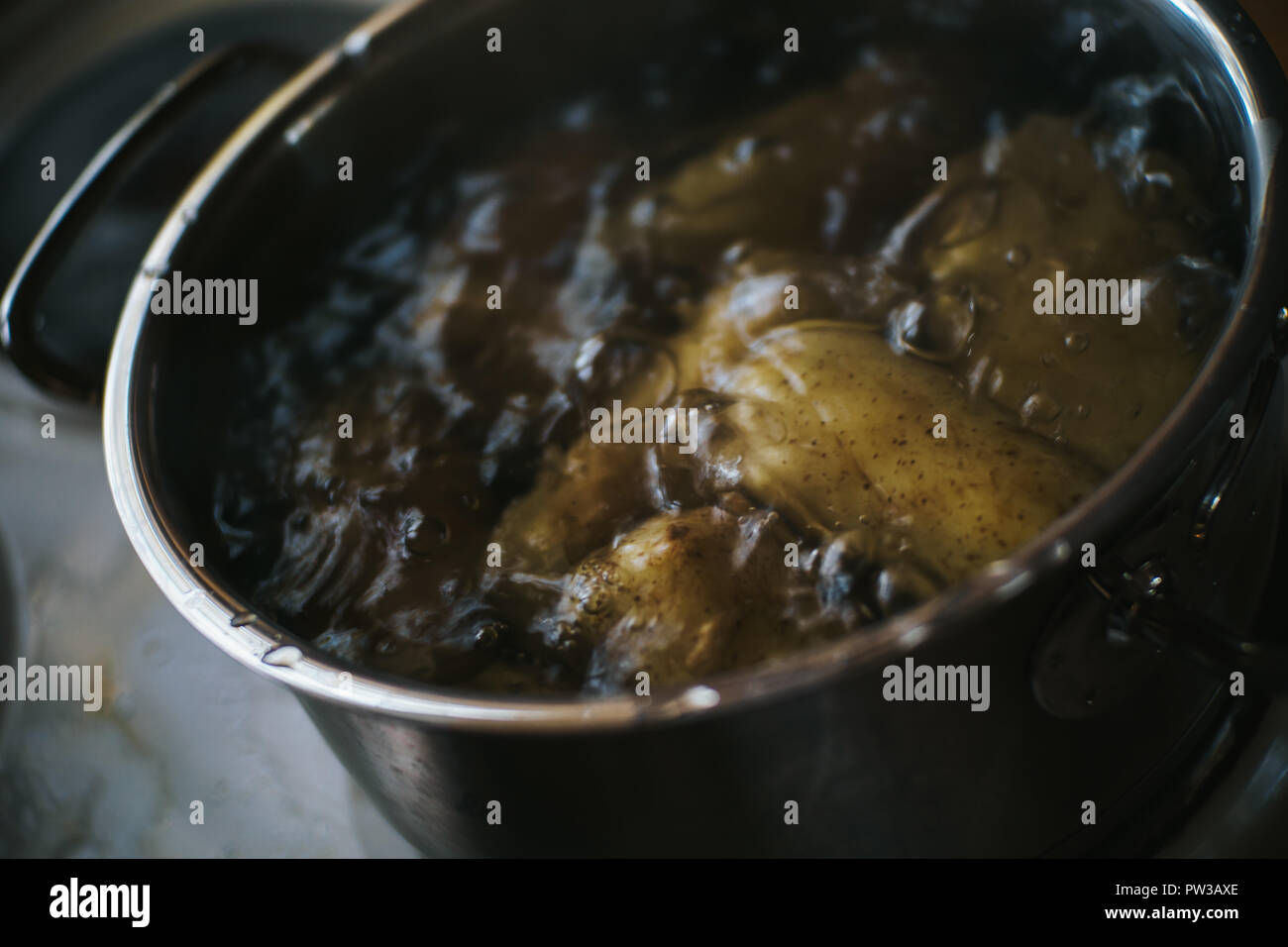 photo of pot filled with potatoes and boiling water on a stove Stock ...