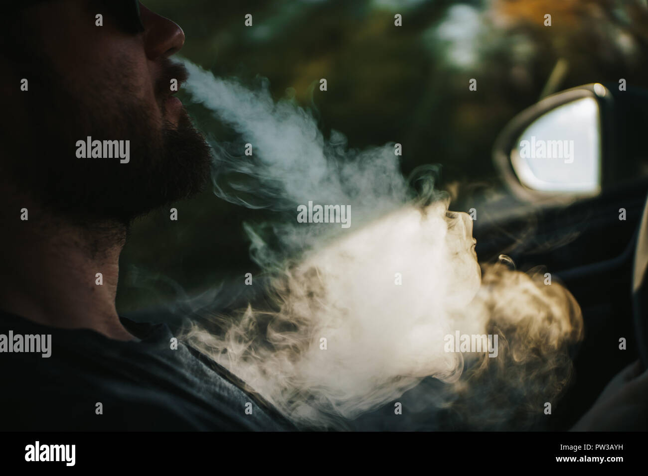 Man exhaling cigarette smoke hi-res stock photography and images - Alamy