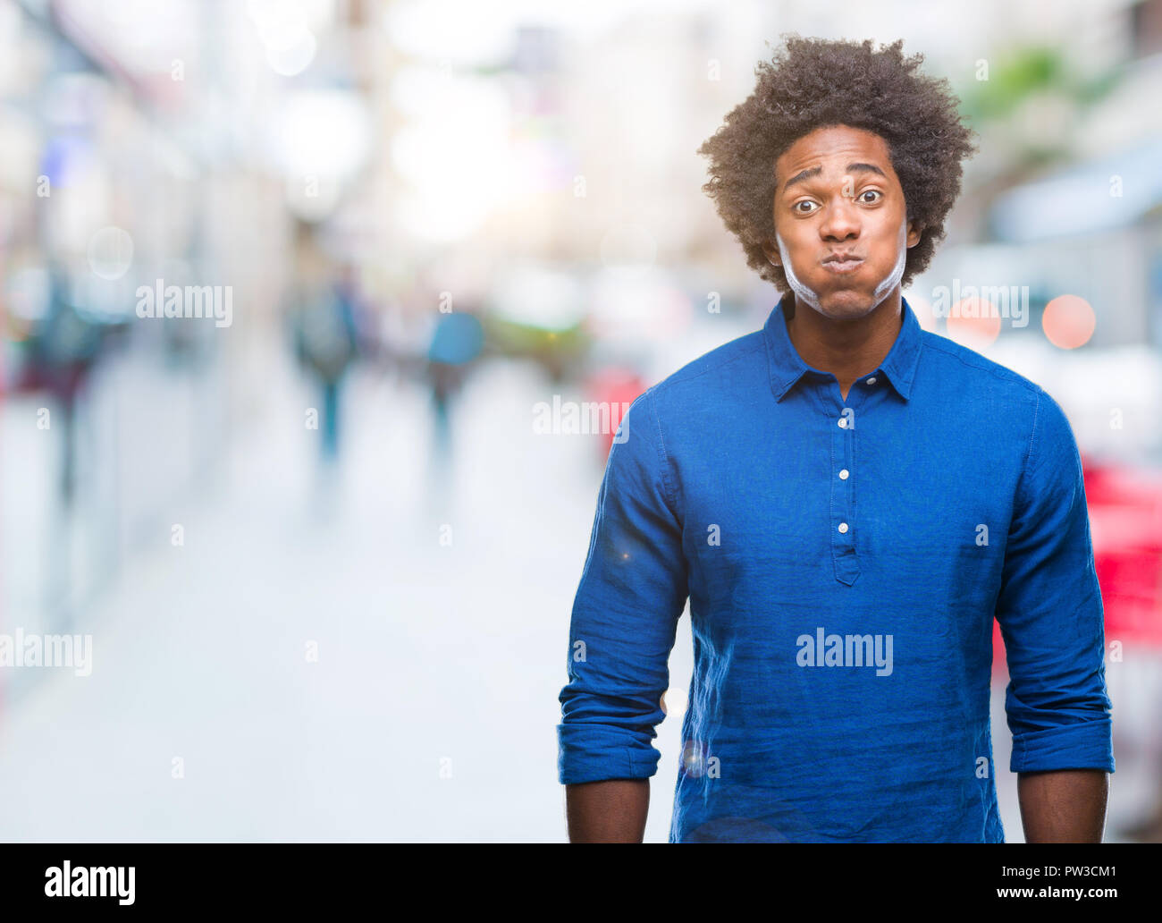 Afro american man over isolated background puffing cheeks with funny ...