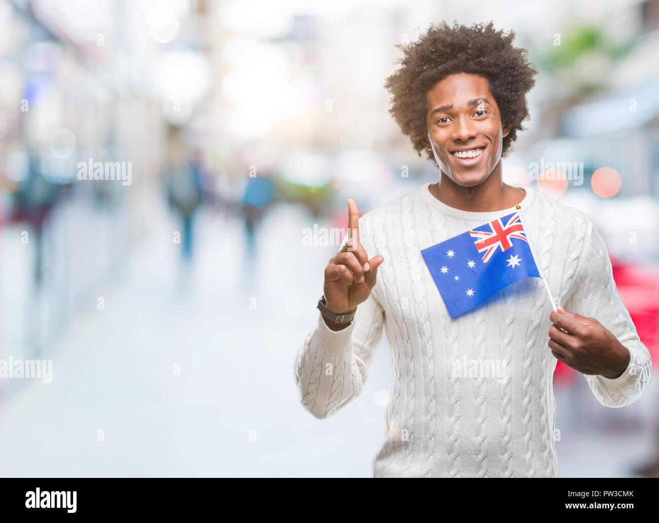 Afro american man flag of Australia over isolated background surprised ...