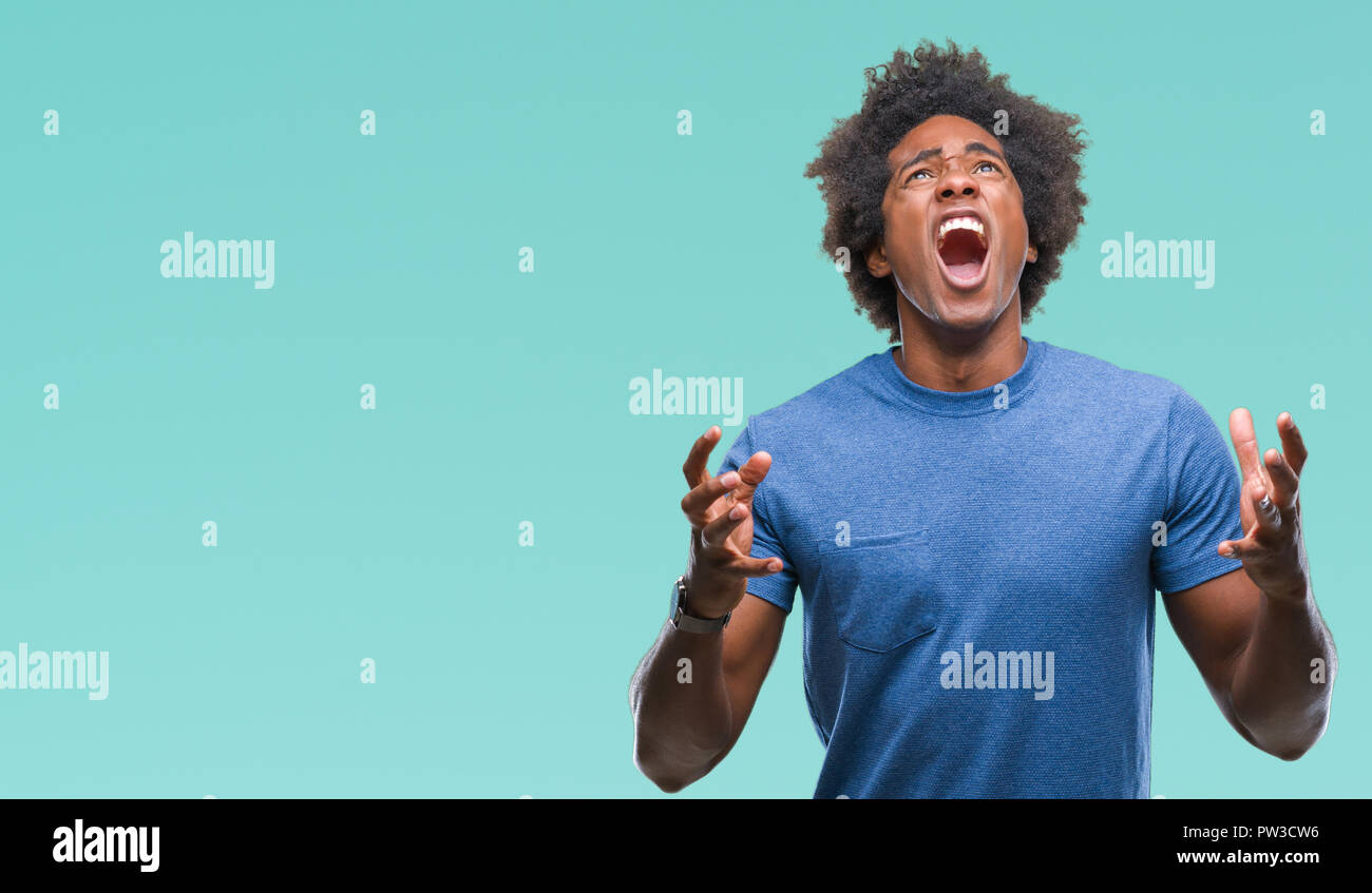 Afro american man over isolated background crazy and mad shouting and ...