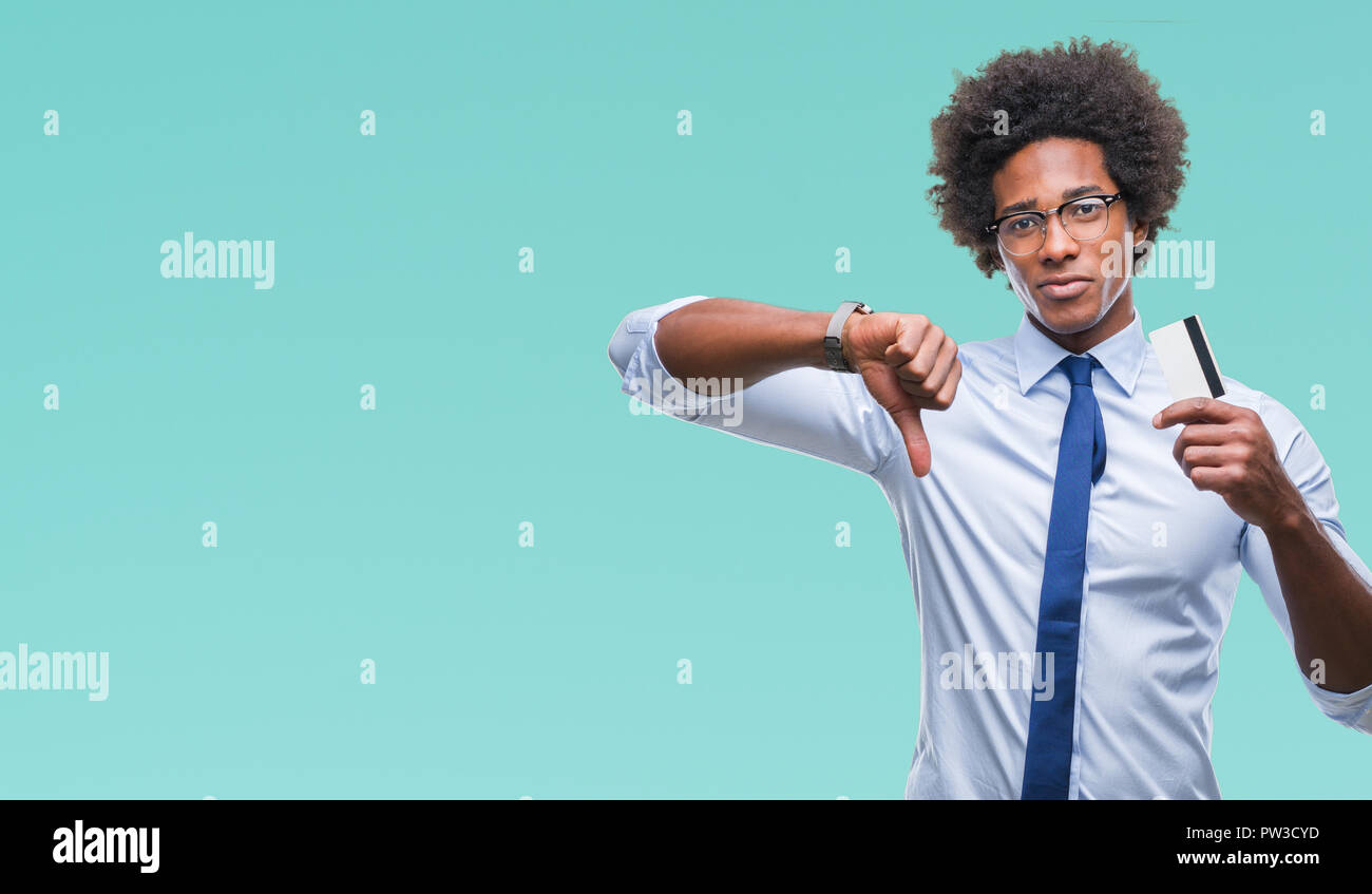 Afro american man holding credit card over isolated background with ...