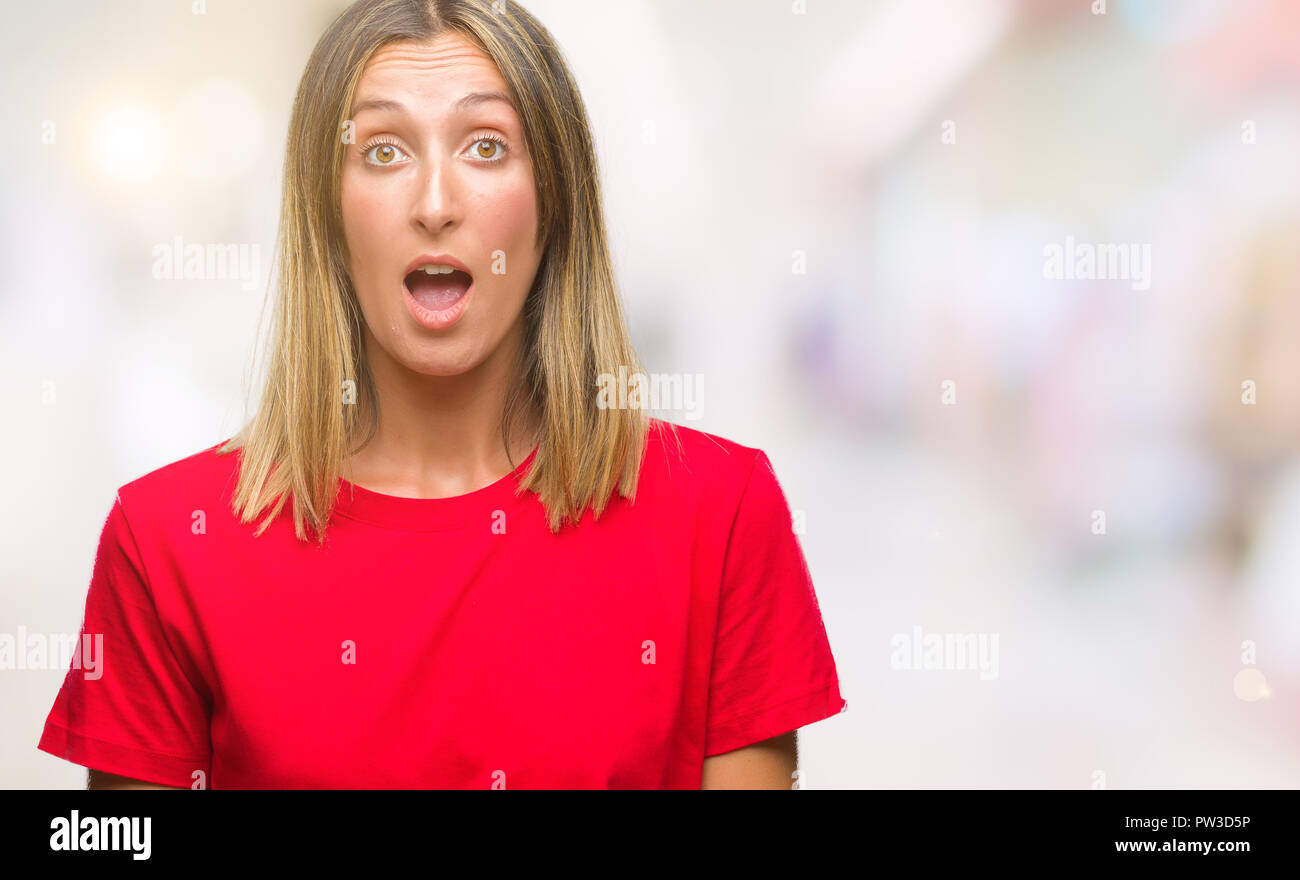 Young beautiful woman over isolated background afraid and shocked with ...
