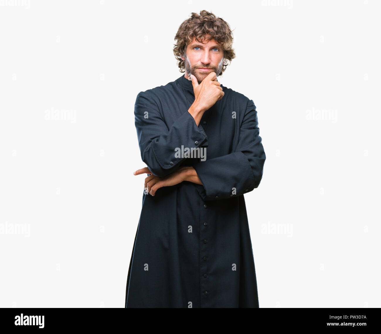Handsome hispanic catholic priest man over isolated background looking ...
