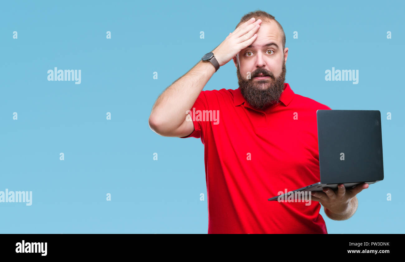 Young caucasian man using computer laptop over isolated background ...