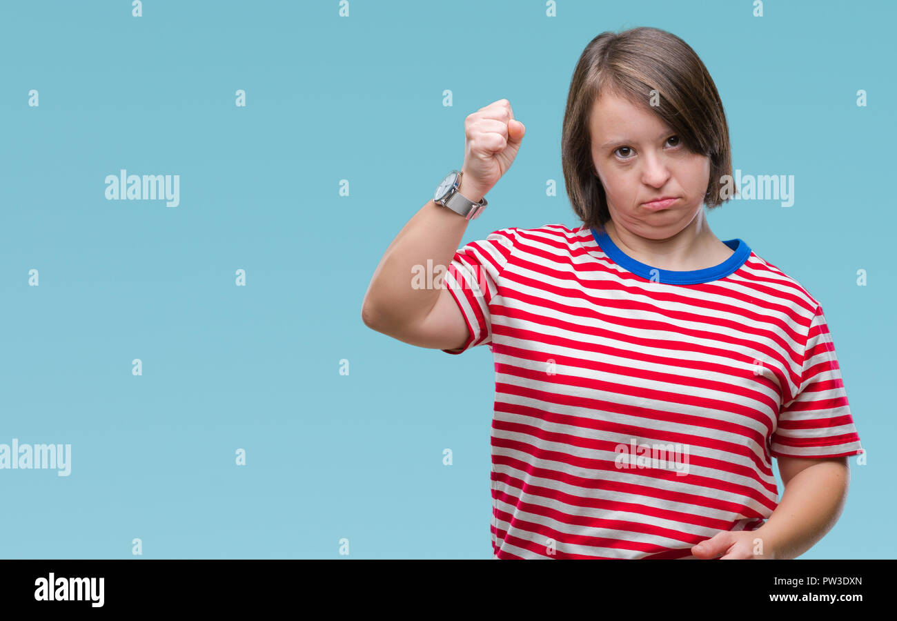 Young adult woman with down syndrome over isolated background angry and ...