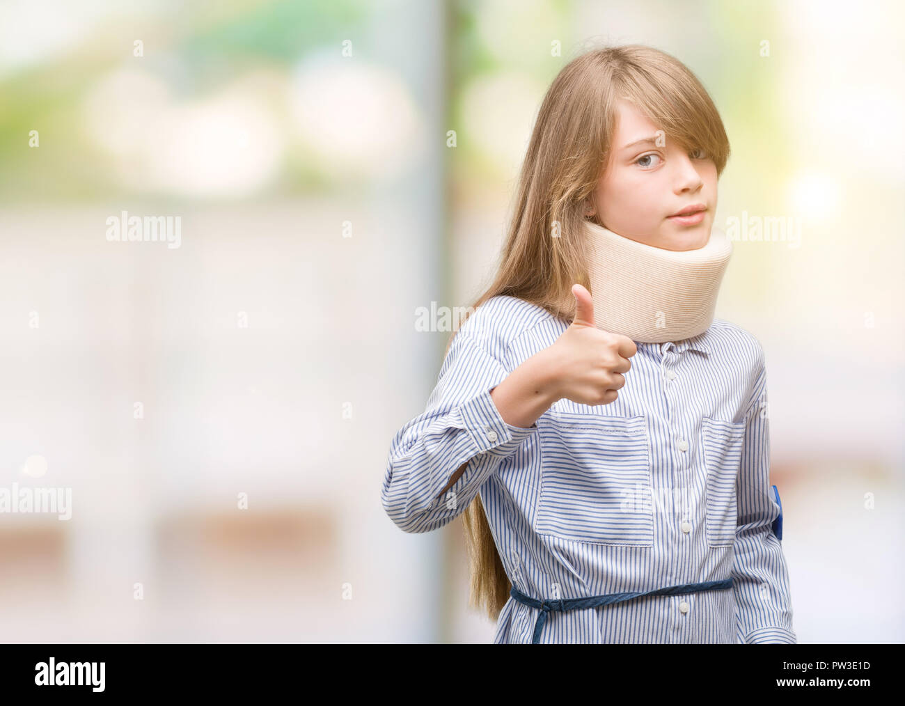 Young blonde child injured wearing neck collar and crutches happy with ...