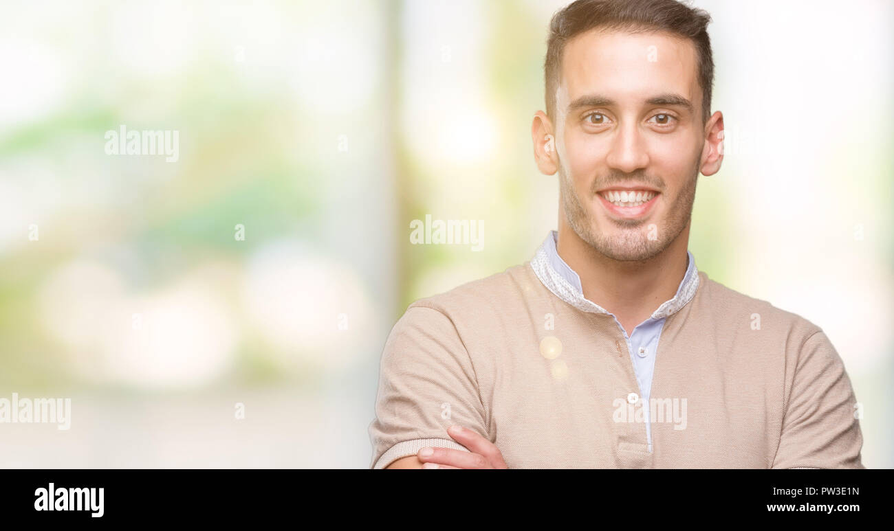 Handsome young man with a happy face standing and smiling with a ...