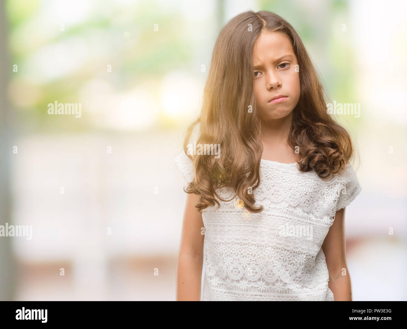 Brunette hispanic girl skeptic and nervous, frowning upset because of ...