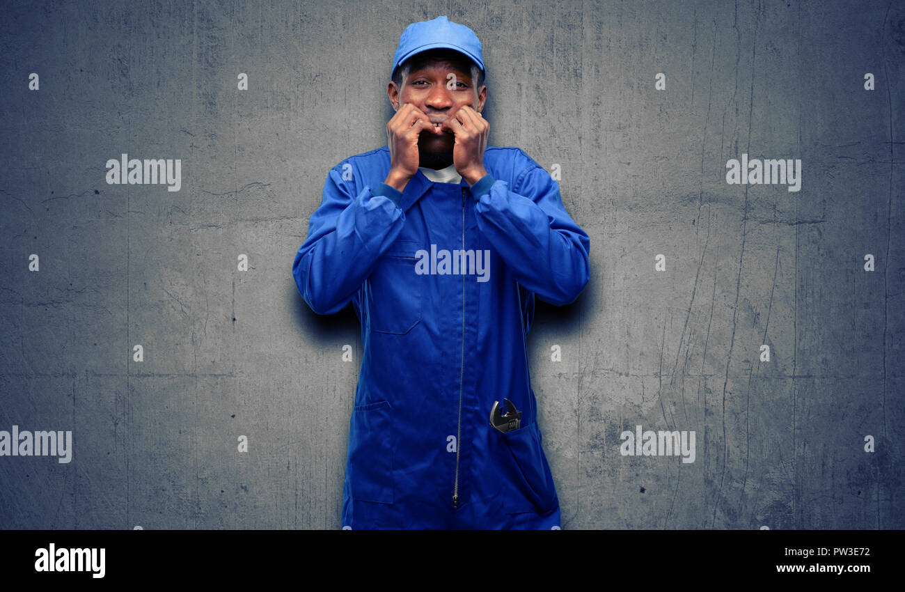 African black plumber man terrified and nervous expressing anxiety and ...