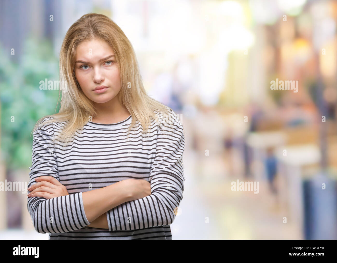 Young caucasian woman over isolated background skeptic and nervous ...