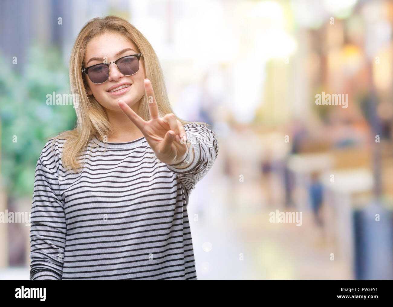 Young caucasian woman wearing sunglasses over isolated background ...