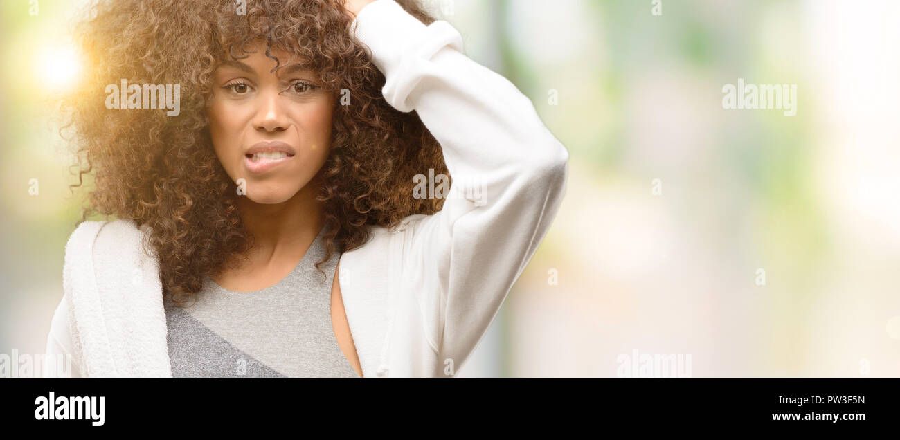 African american fitness woman holding water bottle stressed with hand ...