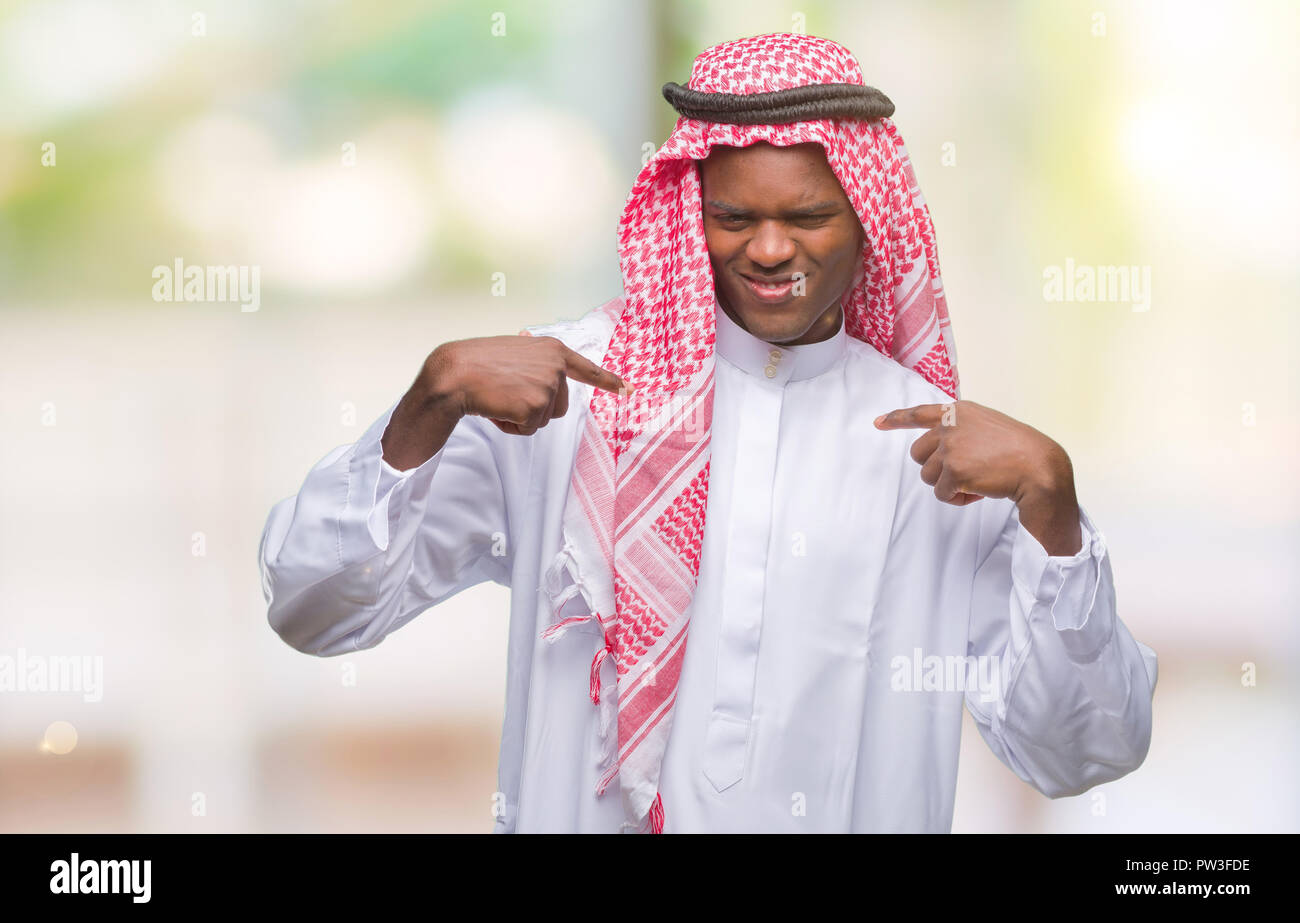 Young arabic african man wearing traditional keffiyeh over isolated ...