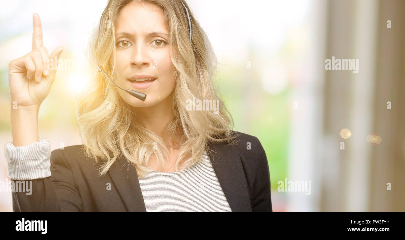 Young woman operator from call center happy and surprised cheering ...