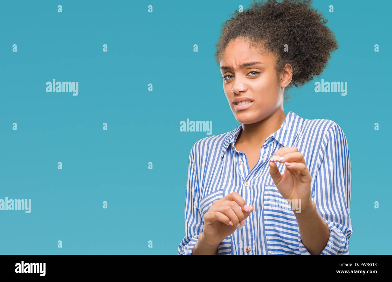 Young afro american woman over isolated background disgusted expression ...