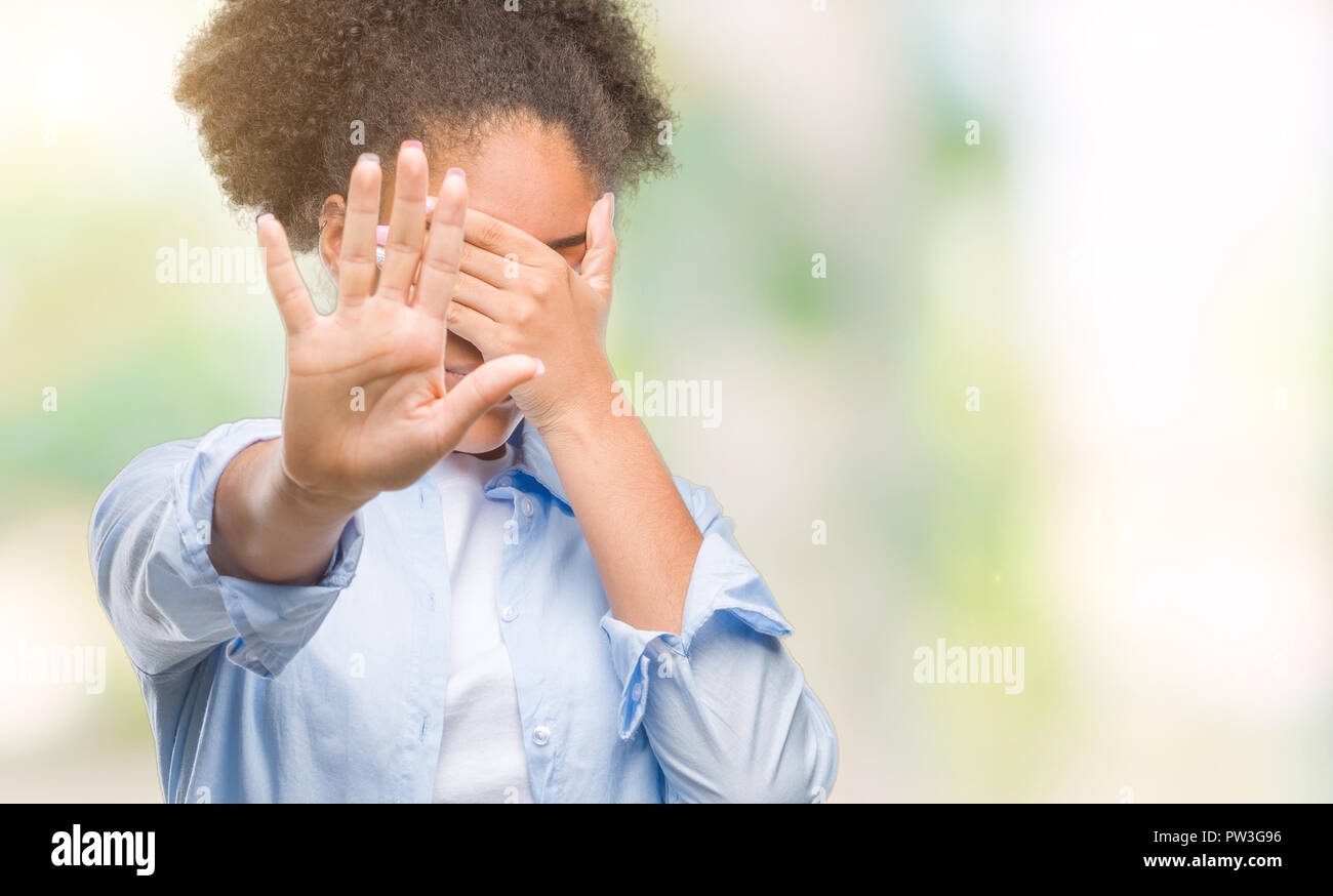 Young afro american woman over isolated background covering eyes with ...