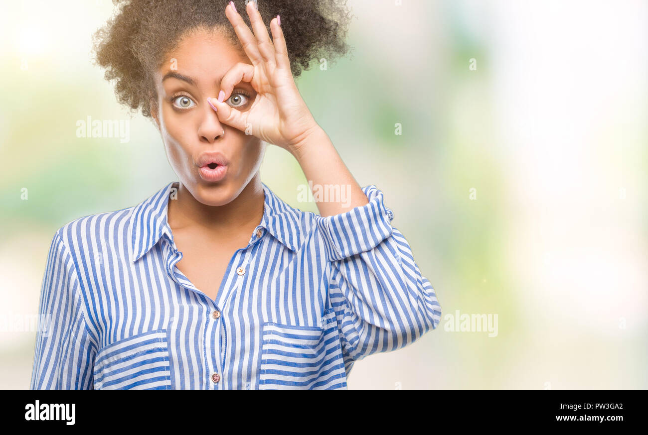 Young afro american woman over isolated background doing ok gesture ...