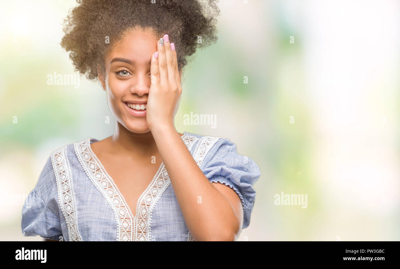 Young afro american woman over isolated background covering one eye ...