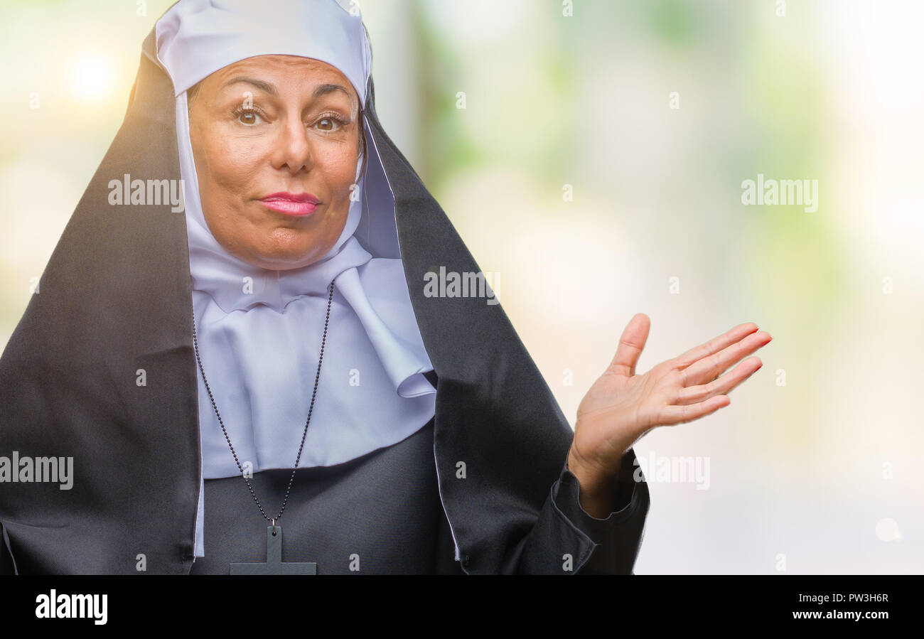 Middle age senior christian catholic nun woman over isolated background ...