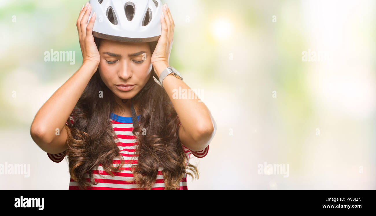 Young arab cyclist woman wearing safety helmet over isolated background ...