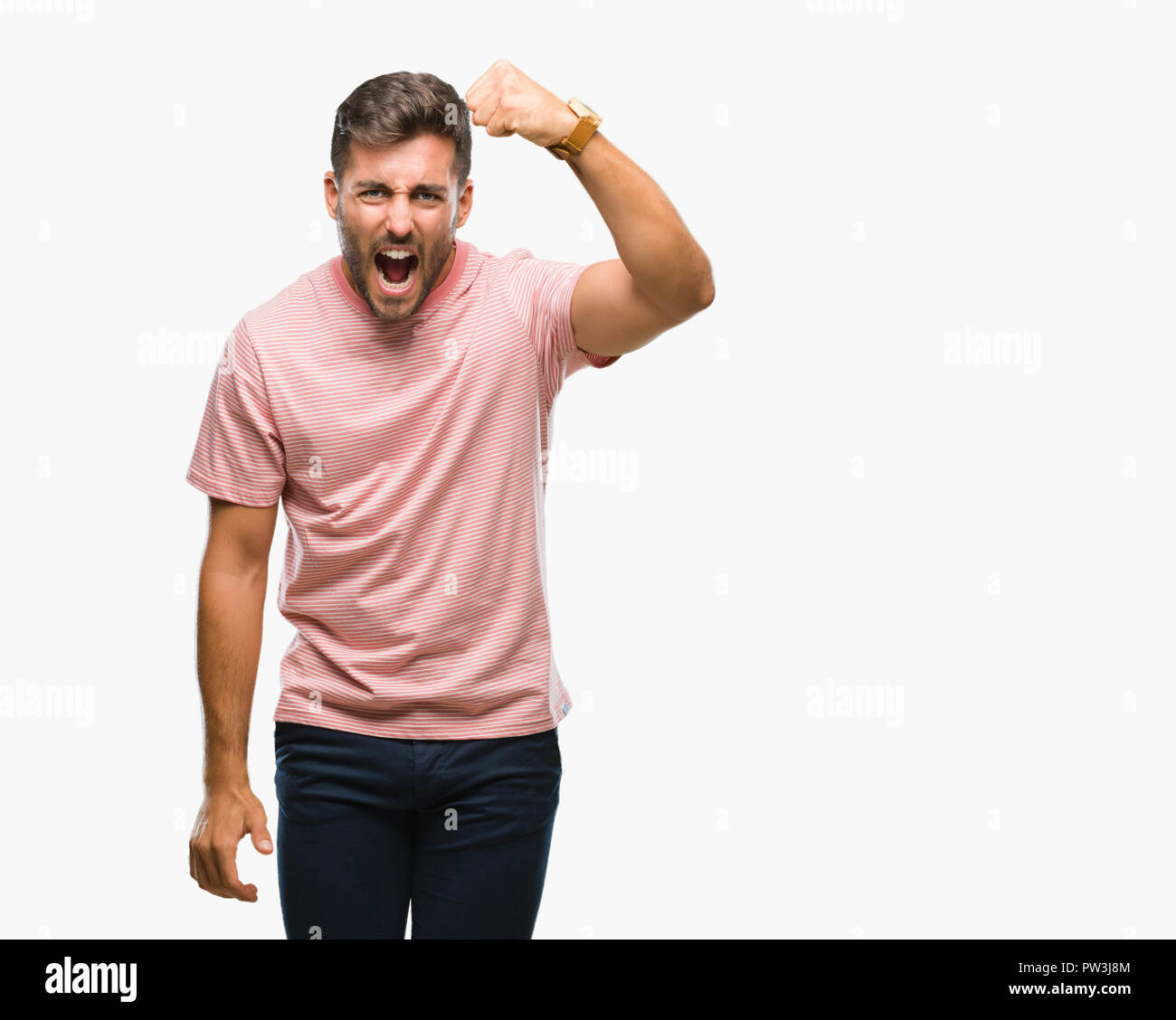 Young handsome man over isolated background angry and mad raising fist ...