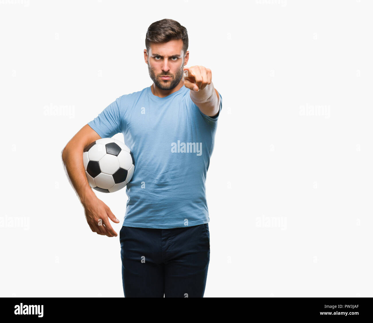 Young handsome man holding soccer football ball over isolated ...