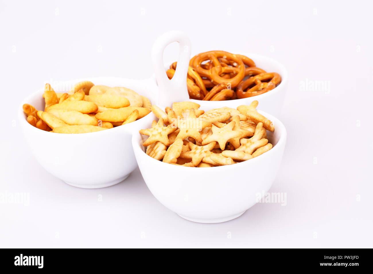 Different salted crackers in bowl isolated on white background Stock ...
