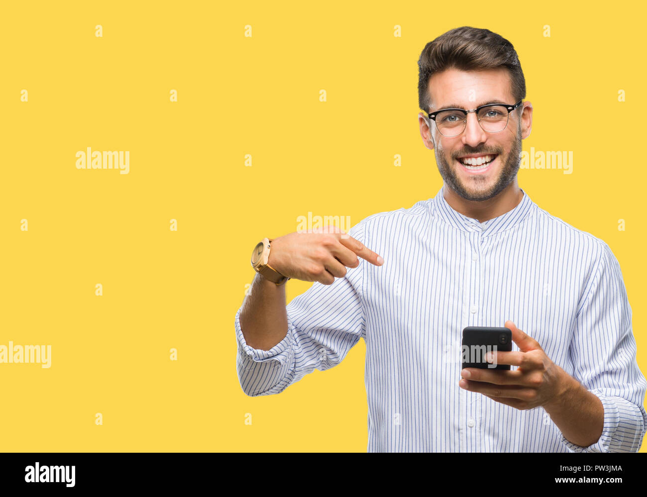 Young handsome man texting using smartphone over isolated background ...
