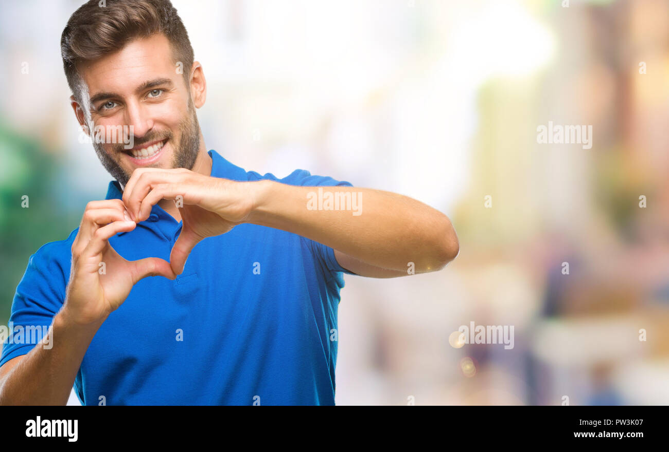 Young handsome man over isolated background smiling in love showing ...