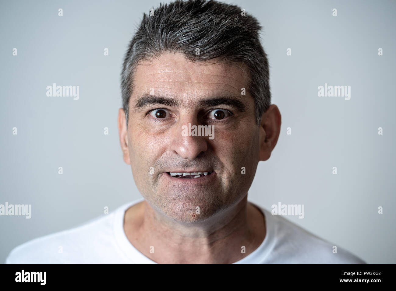Portrait of a mature 40s to 50s white angry and upset man looking ...