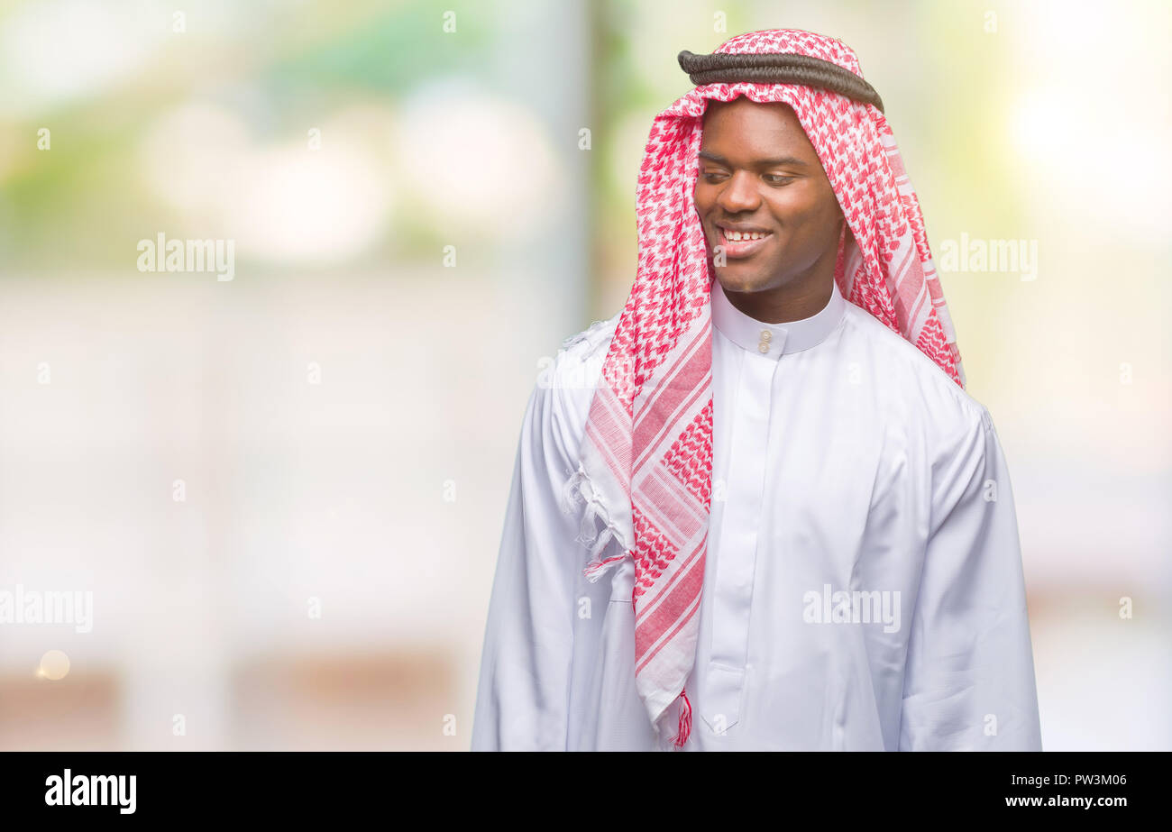 Young arabic african man wearing traditional keffiyeh over isolated ...