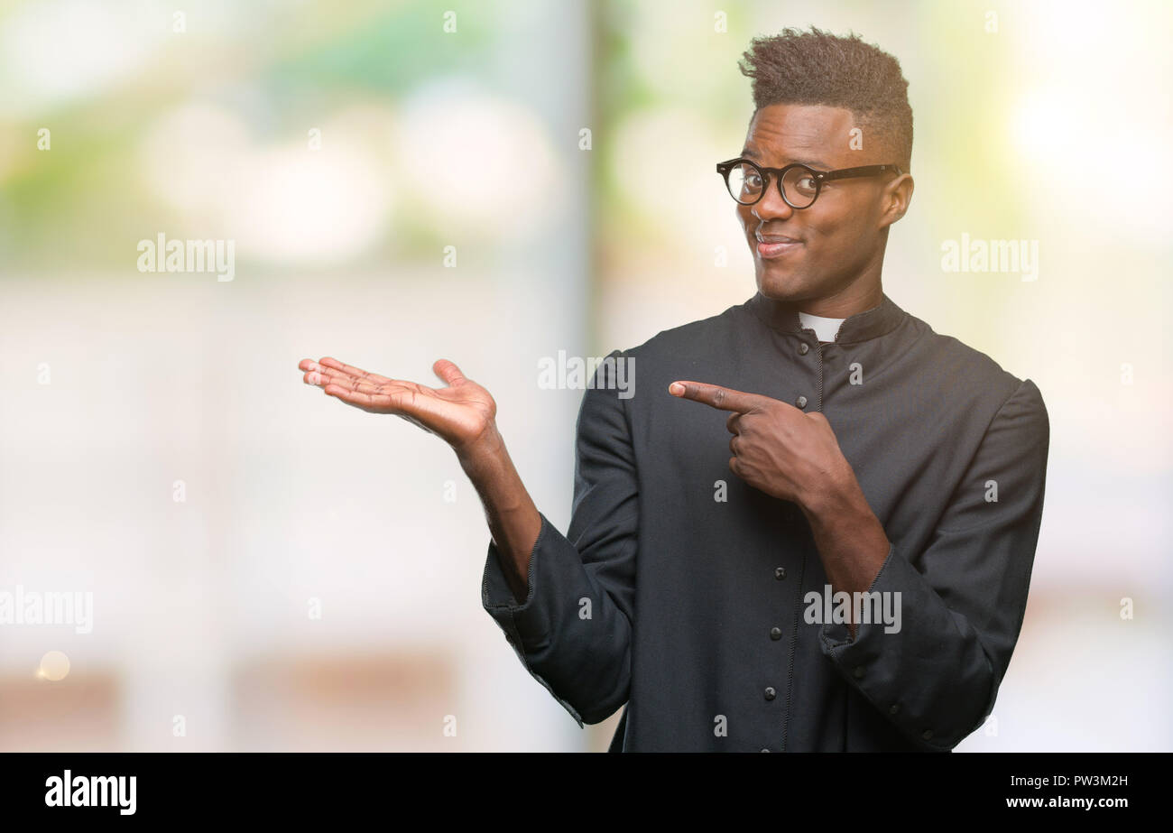 Portrait african smiling priest pointing hi-res stock photography and ...