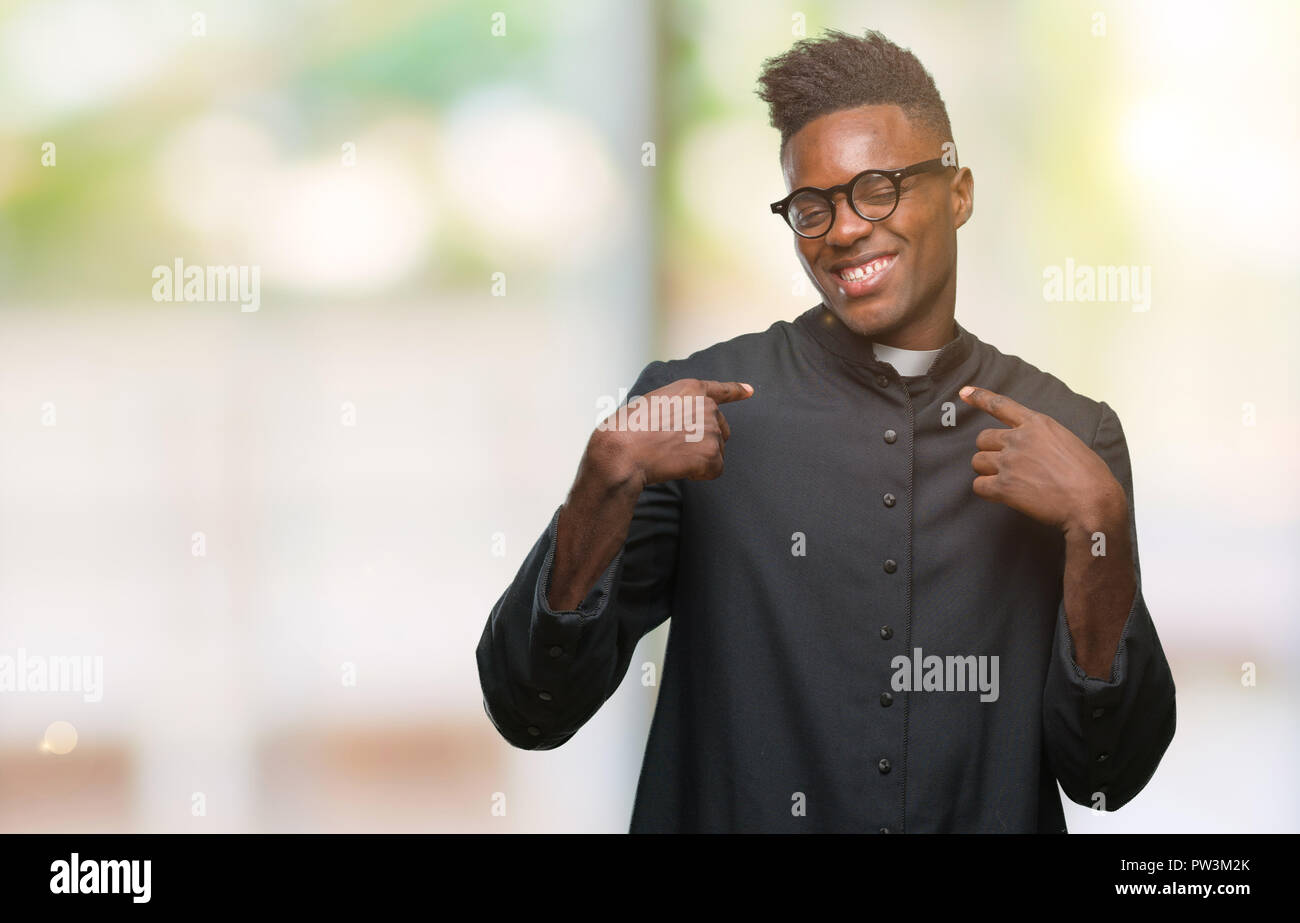 Portrait african smiling priest pointing hi-res stock photography and ...