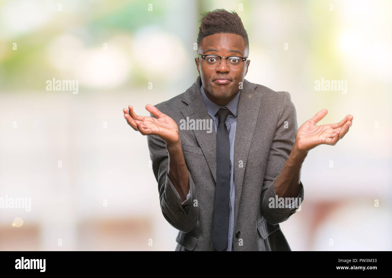 Young african american business man over isolated background clueless ...